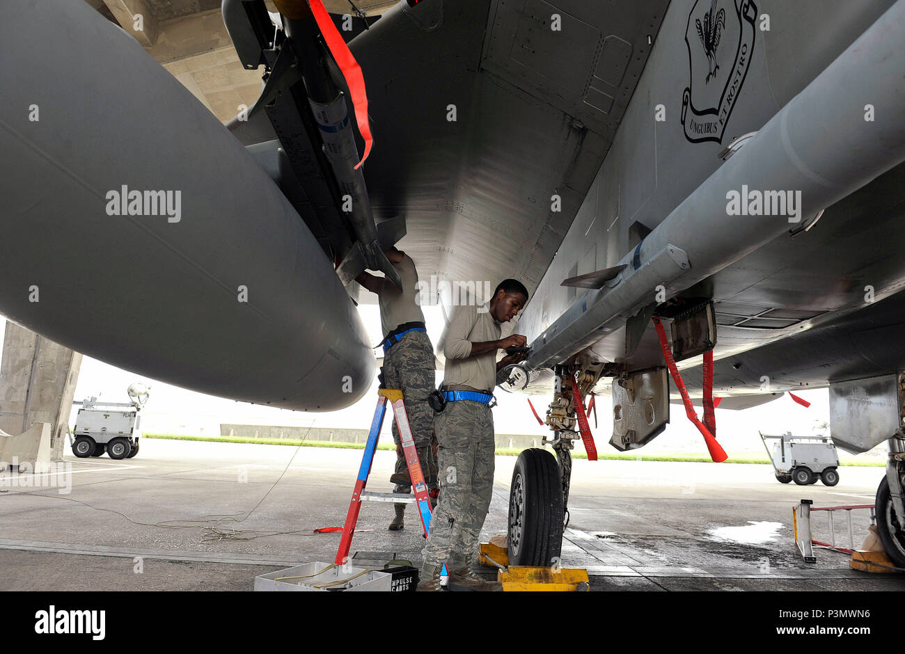 A U.S. Air Force weapons load crew from the 44th Aircraft Maintenance ...