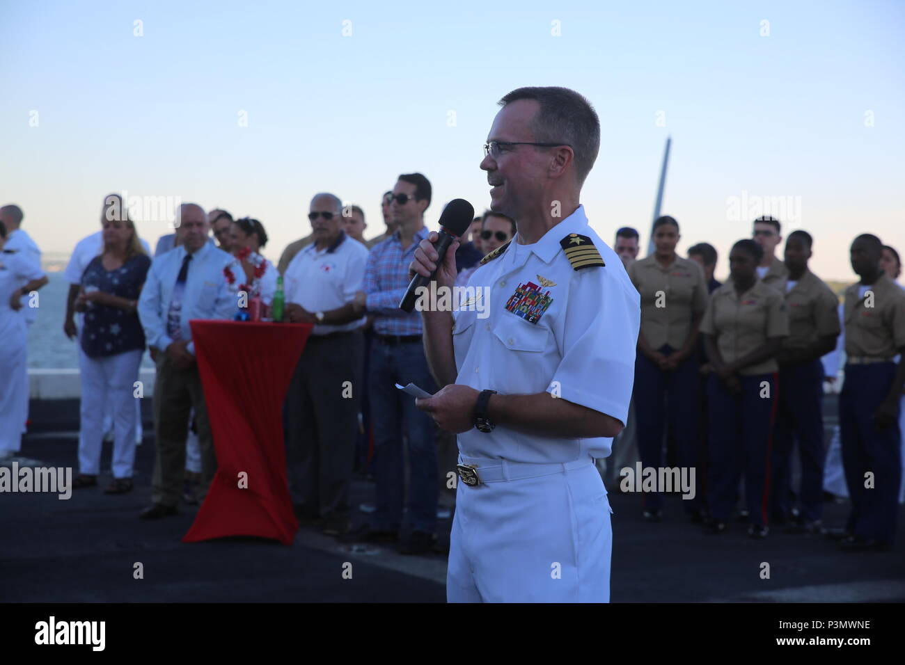 Navy Capt. Sean Bailey, commanding officer of the USS Arlington, gives ...
