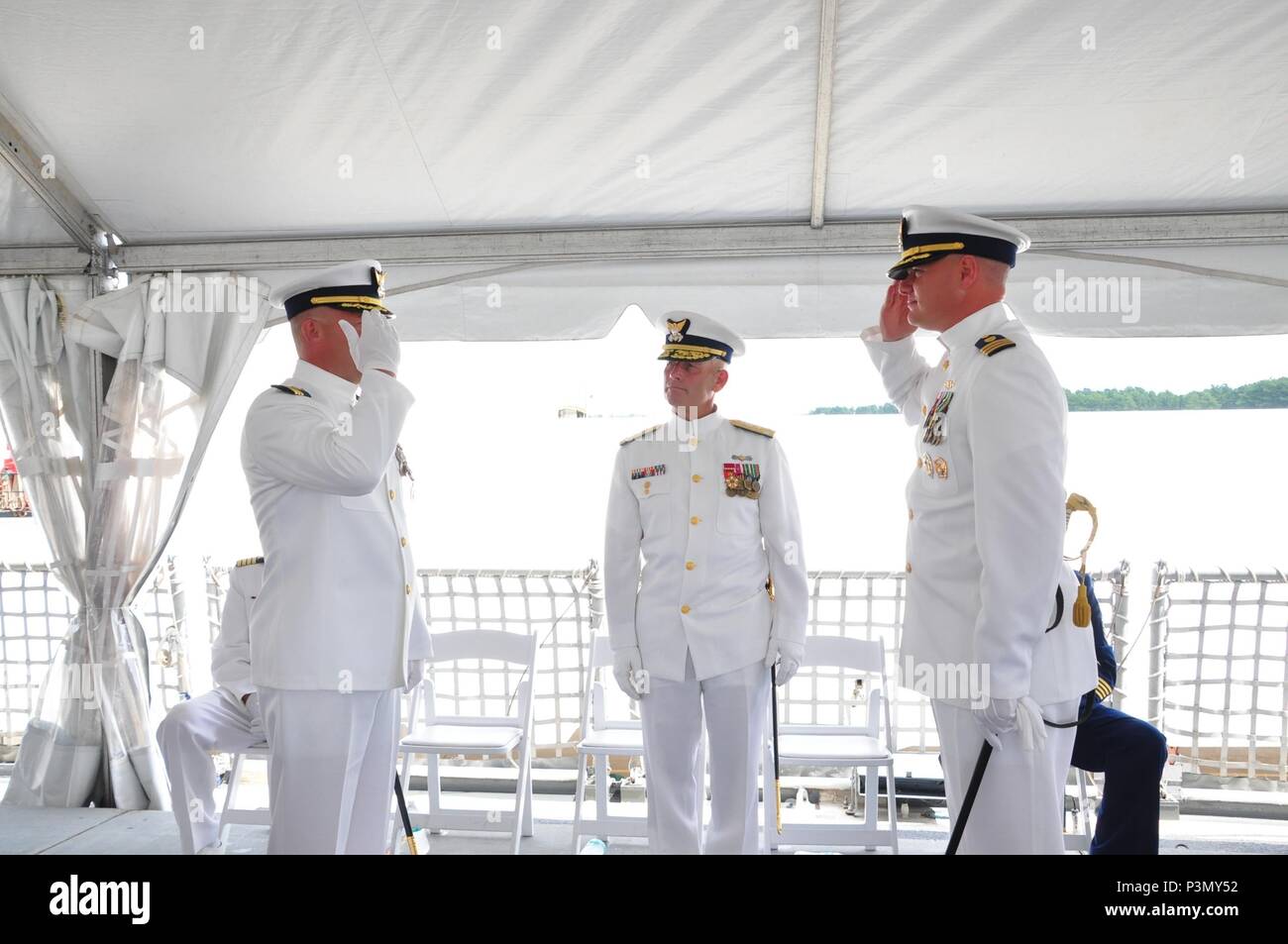 Coast Guard Cmdr. Jonathan A. Carter salutes Cmdr. Todd D. Vance during ...