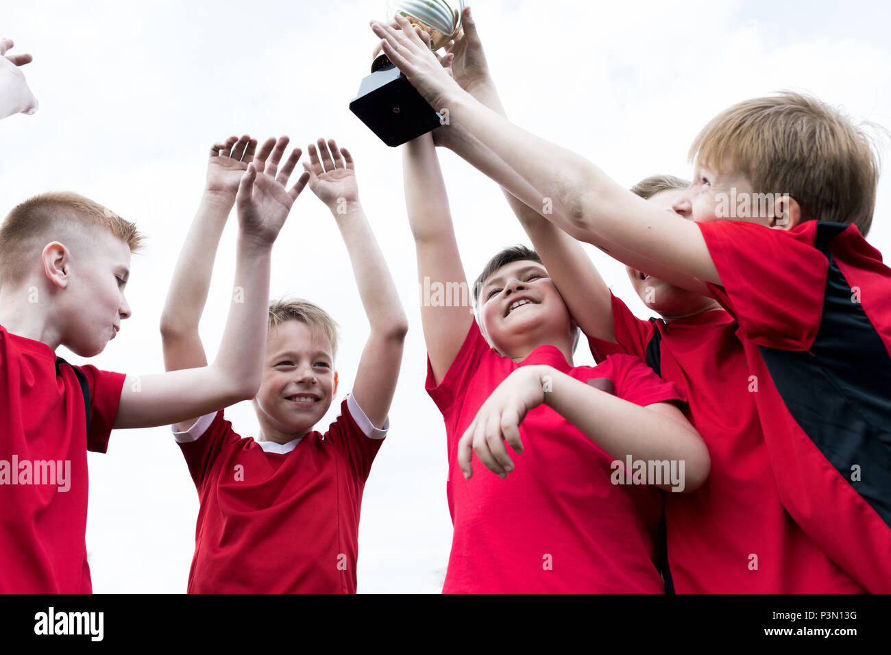 Junior Team Holding Trophy Cup Stock Photo - Alamy