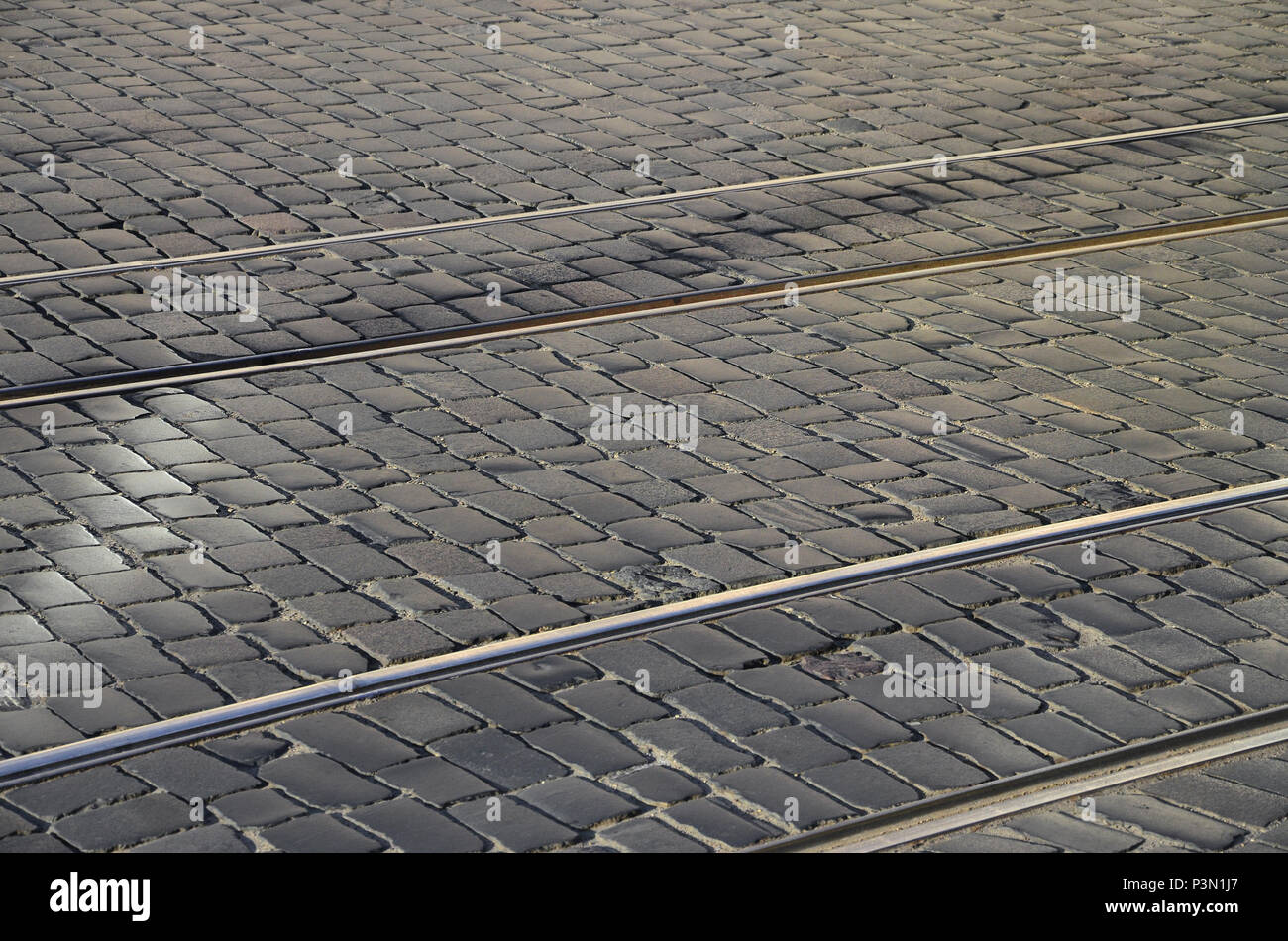 Metal tram rails in the middle of the road, laid out of a smooth paving ...