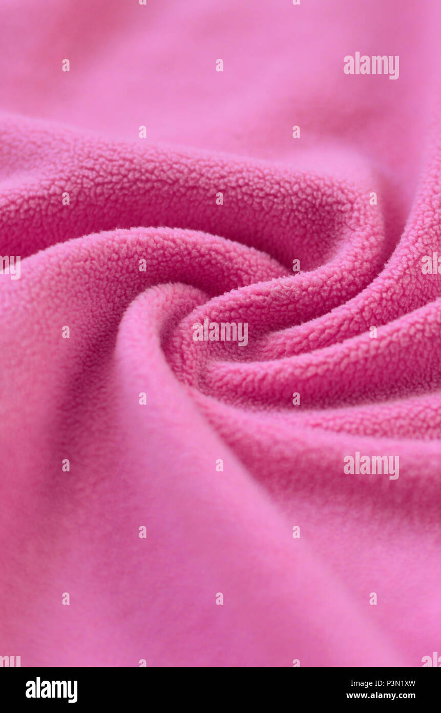 The blanket of furry pink fleece fabric. A background of light pink ...