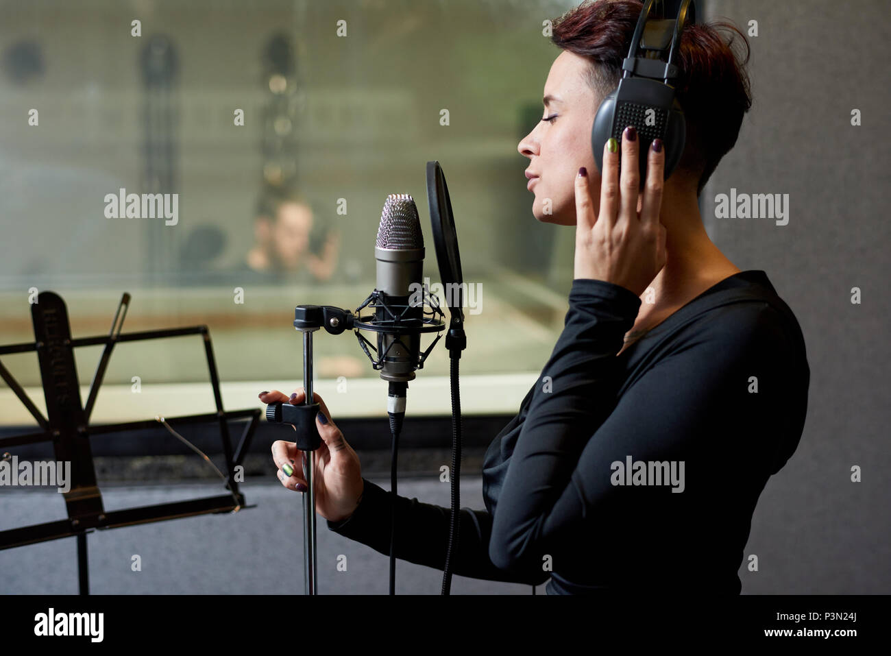 Stylish singer recording sing Stock Photo - Alamy