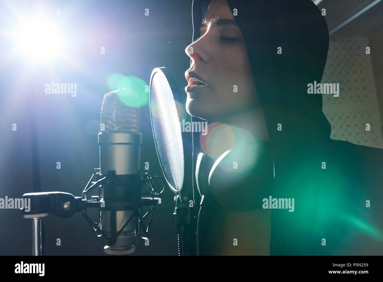 Amazing girl singing in back lit Stock Photo - Alamy