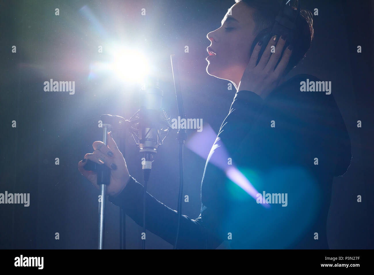Stylish singer in recording studio Stock Photo - Alamy