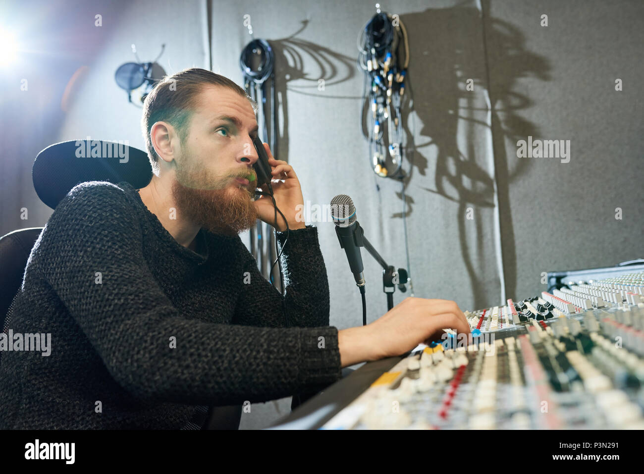 Director with headphones in recording studio Stock Photo - Alamy