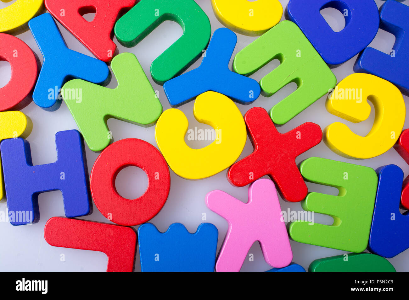 Colorful alphabet letter blocks scattered randomly on white background ...