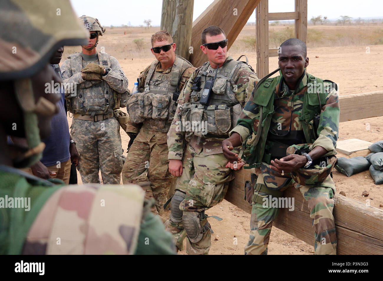 A Senegalese officer (right) with the 1st Paratrooper Battalion gives ...