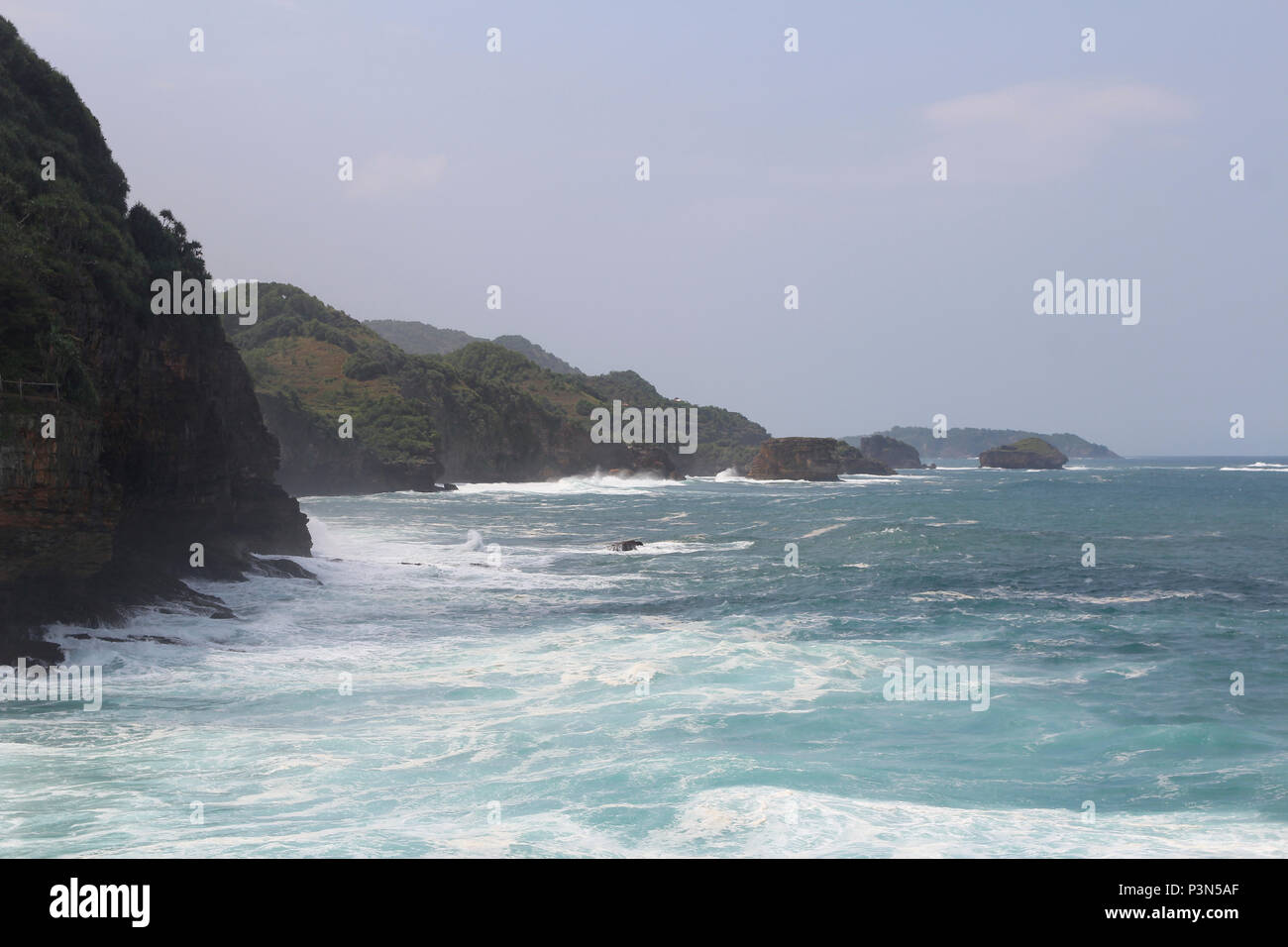 Natural cliff formation with the wave at Timang Beach in sunny day ...
