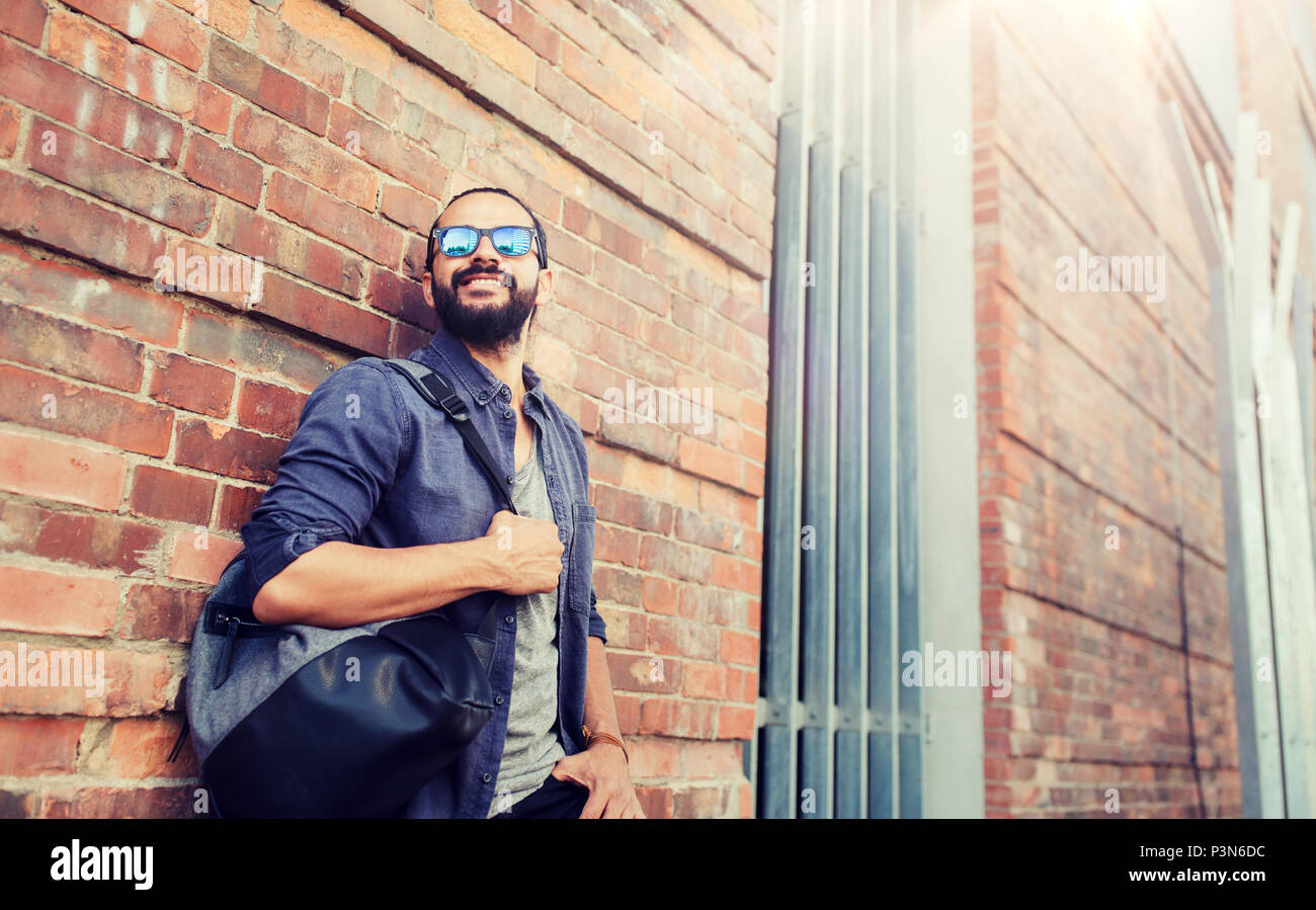 happy man with backpack standing at city street Stock Photo - Alamy