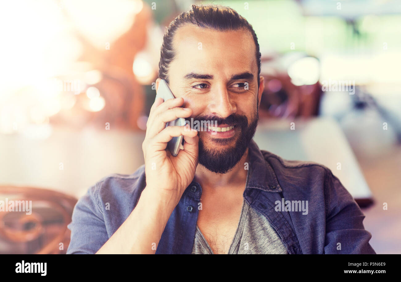 happy man calling on smartphone at bar or pub Stock Photo - Alamy