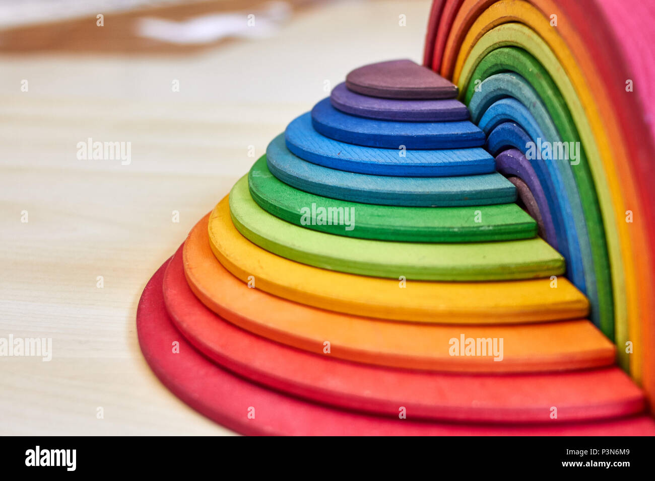 Waldorf rainbow and semicircle stack woodden puzzle Stock Photo - Alamy