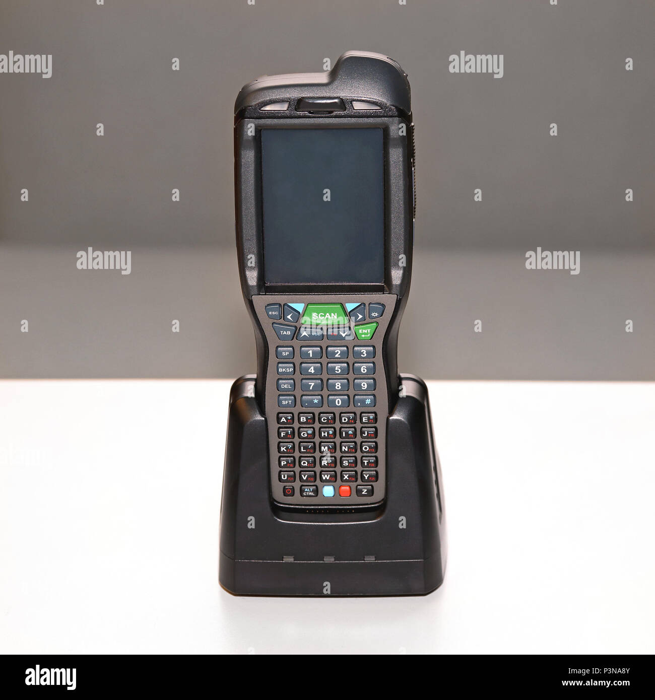 Handheld Laser Barcode Scanner Computer at Charger Dock Stock Photo - Alamy