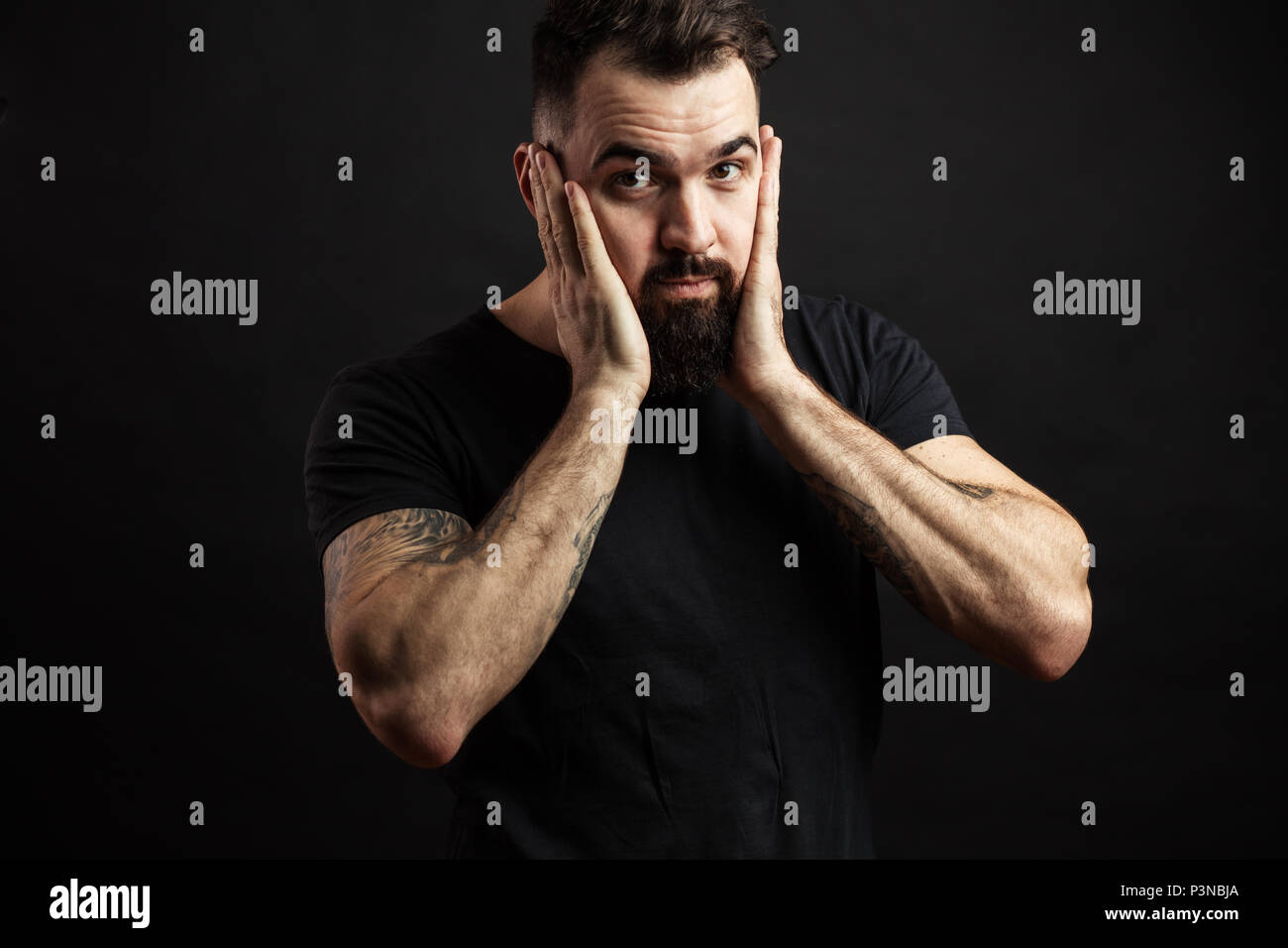 surprised young man isolated on black Stock Photo - Alamy