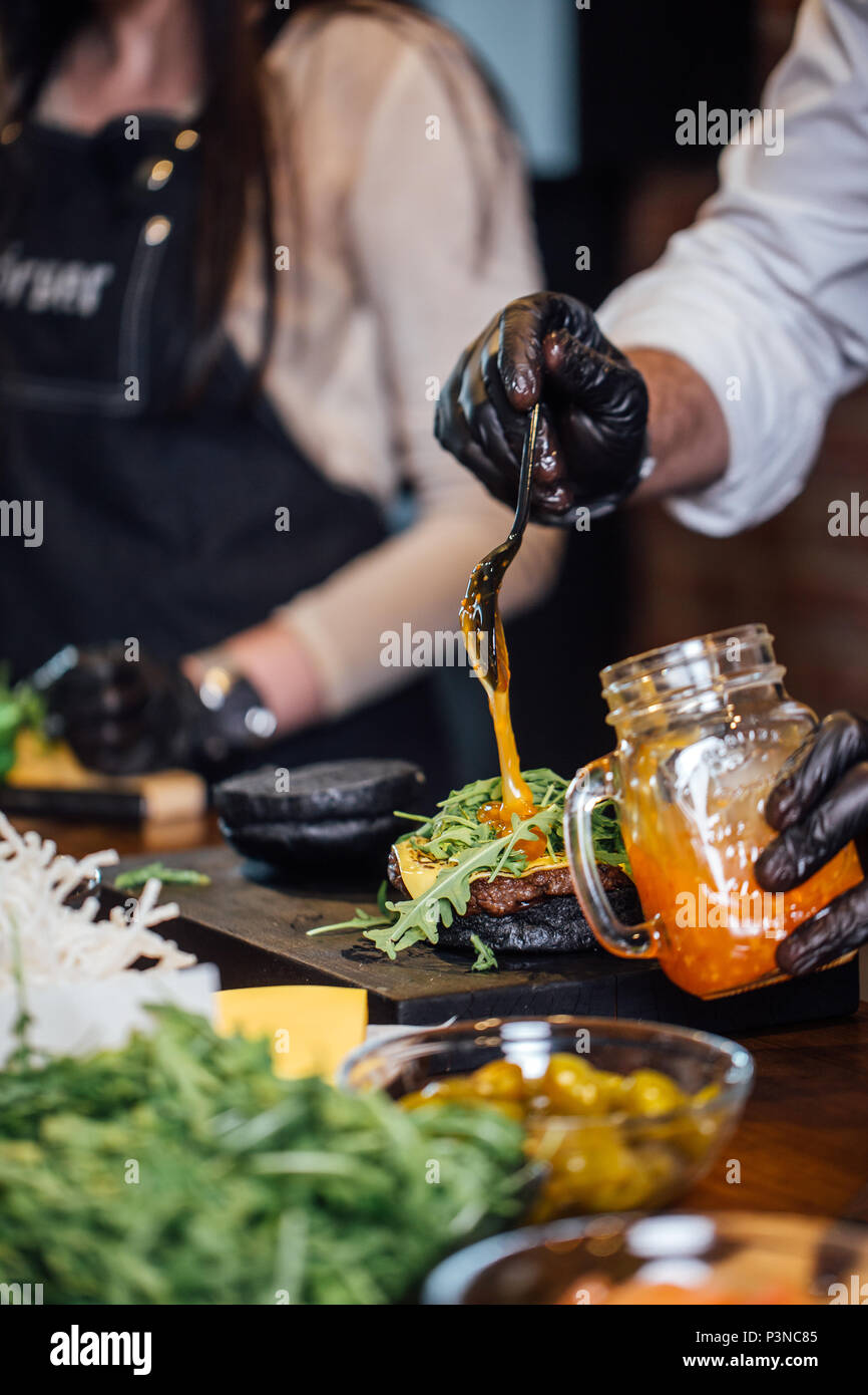 Chef making beef burgers at burger pub Stock Photo - Alamy