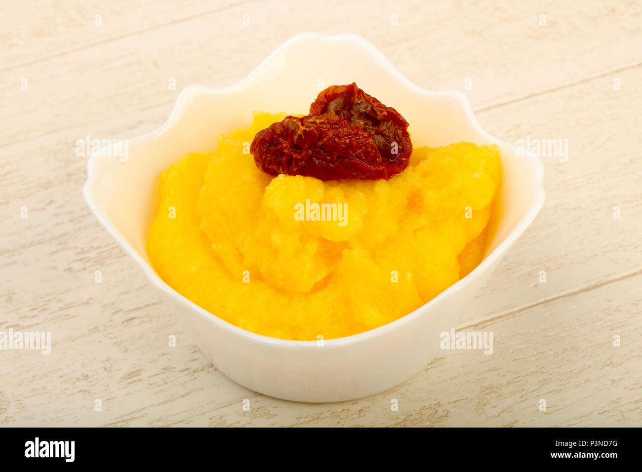 Polenta with dry tomato Stock Photo - Alamy