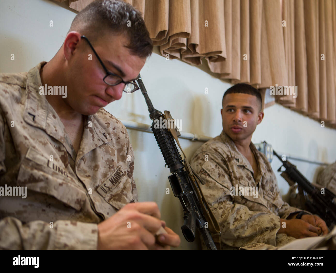 Private first class. Frank D. Lung chats with Lance Cpl. Jaime A. Lugo ...