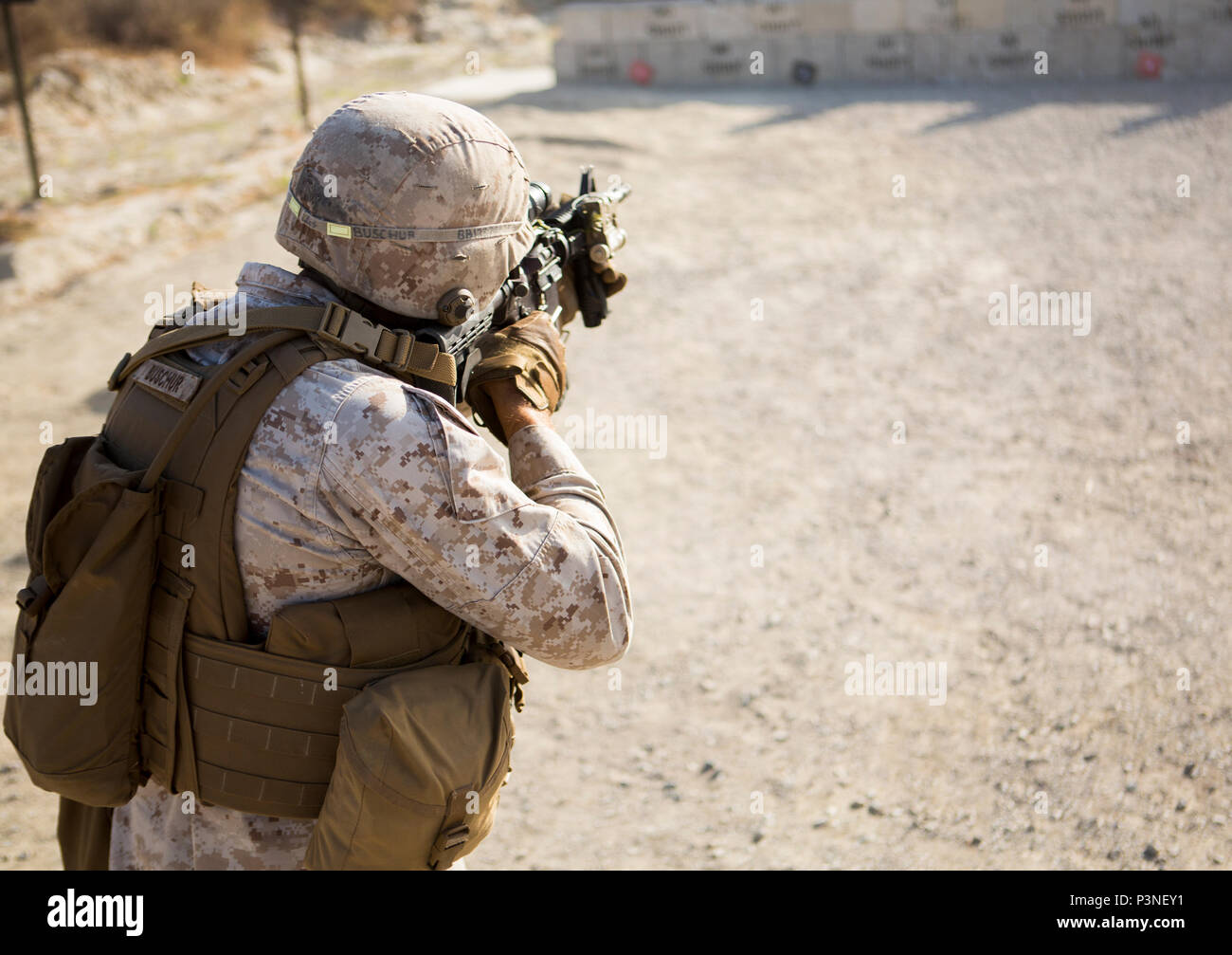 Cpl. Scott J. Buschur takes aim at targets during a combat marksmanship ...