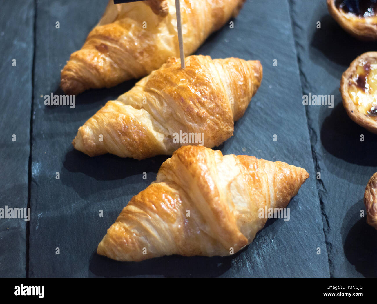 Freshly baked croissants in bakery bread shop on sale in the store ...