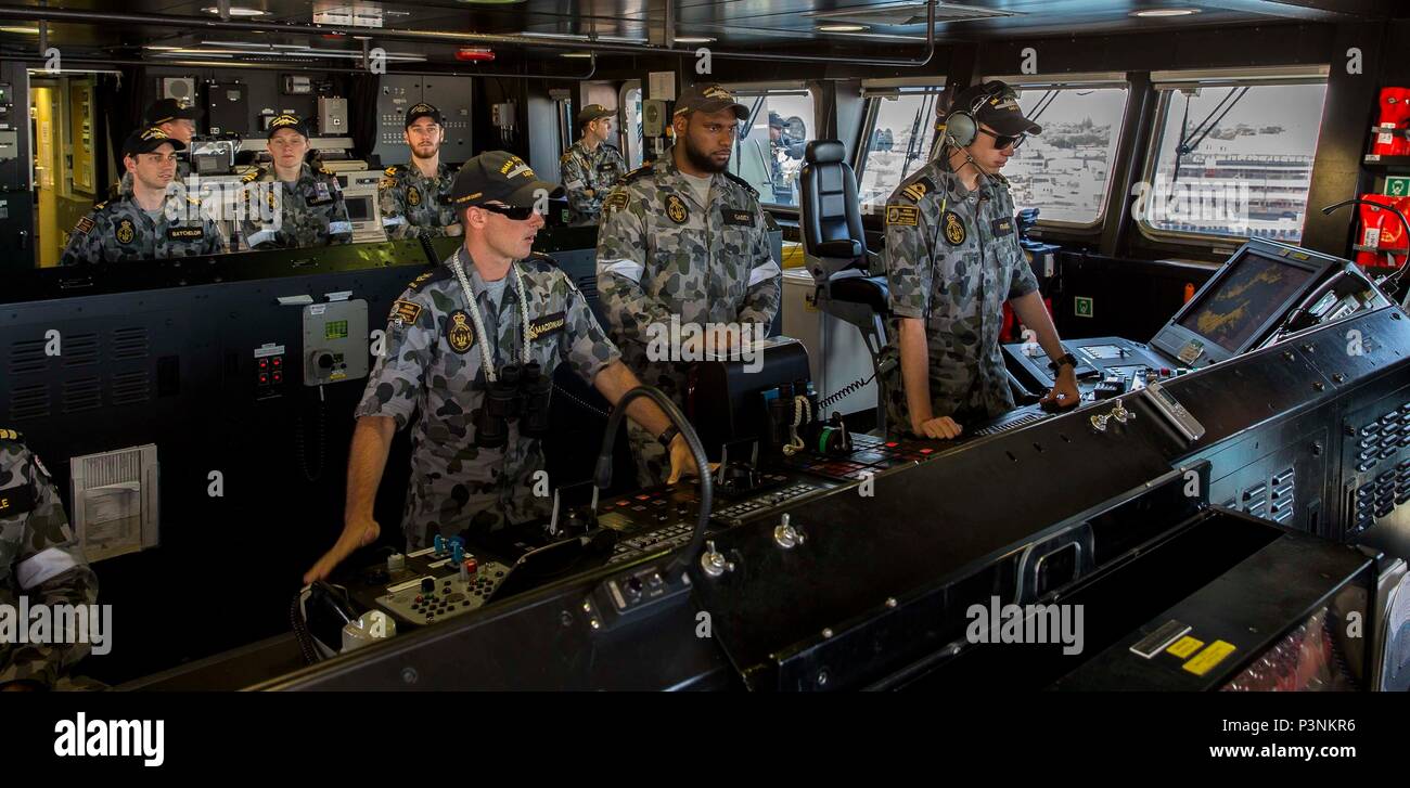 Personnel man the bridge as HMAS Canberra sails from Joint Base Pearl ...
