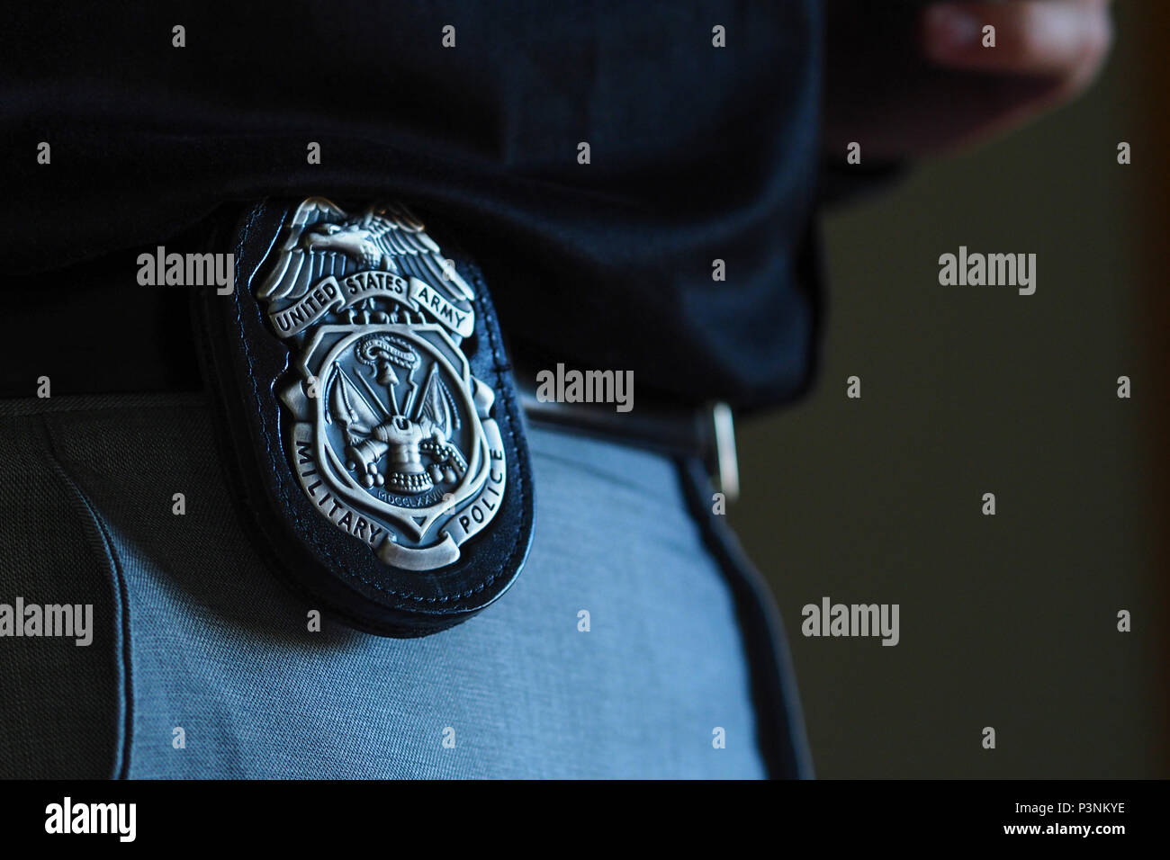 A Military Police badge is seen displayed on the belt of a soldier ...