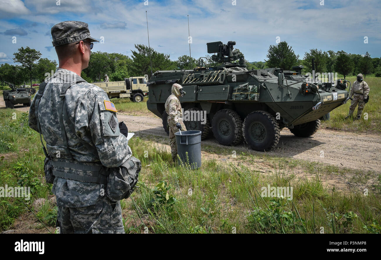 A U.S. Army observer coach trainer (OCT) closely observes U.S. Army ...
