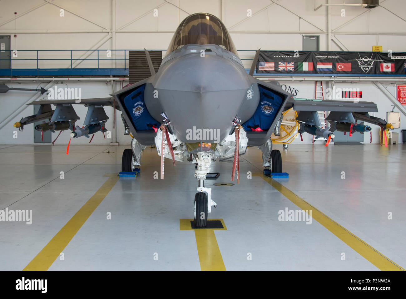 An F-35A from the 58th Fighter Squadron is loaded with weapons in its ...