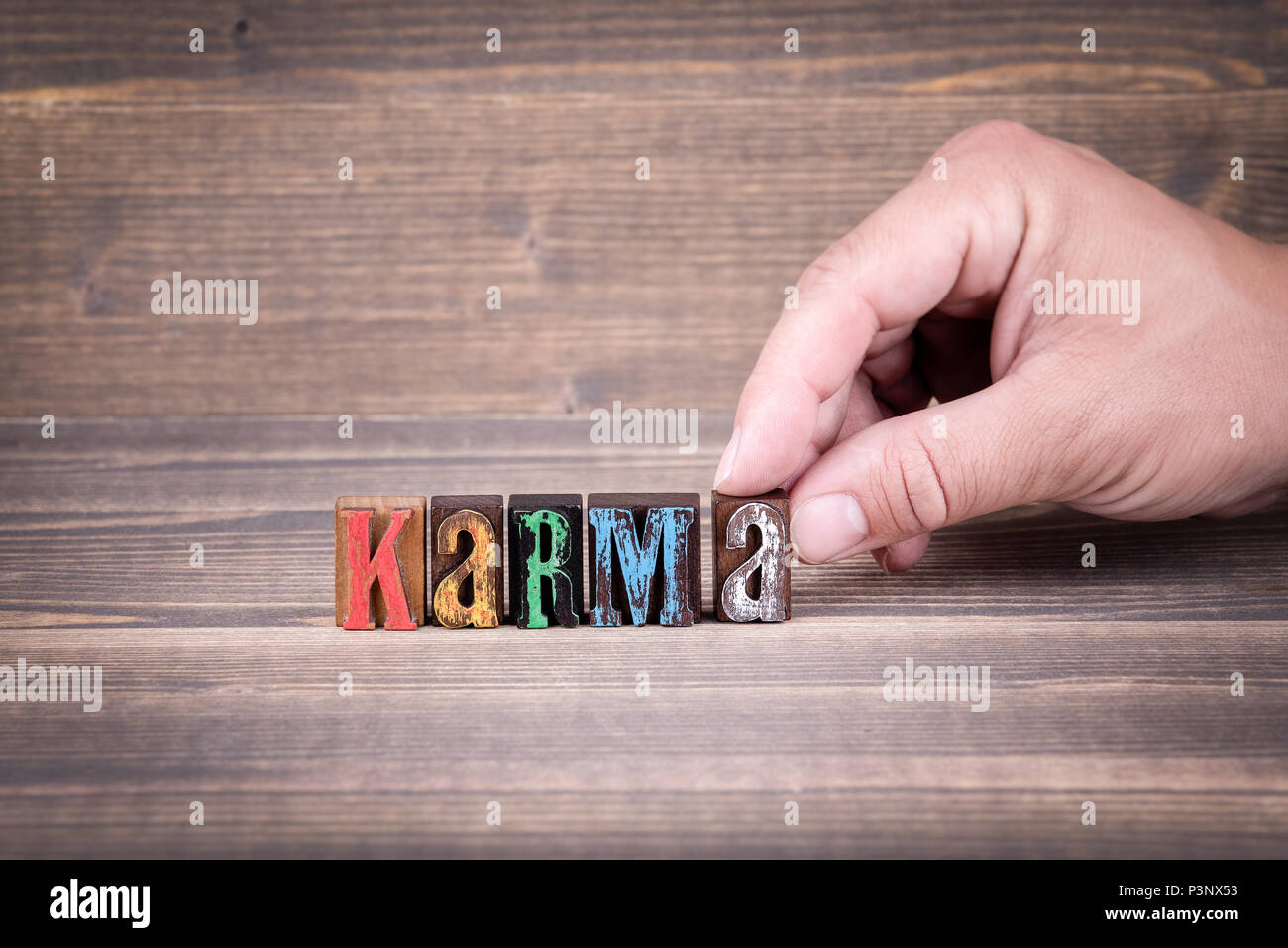 karma. Wooden letters on the office desk Stock Photo - Alamy