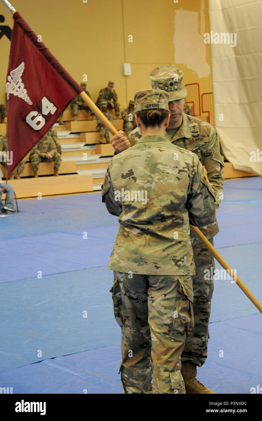 U.S. Army Col. Rebecca I. Evans, outgoing commander, passes the guidon ...
