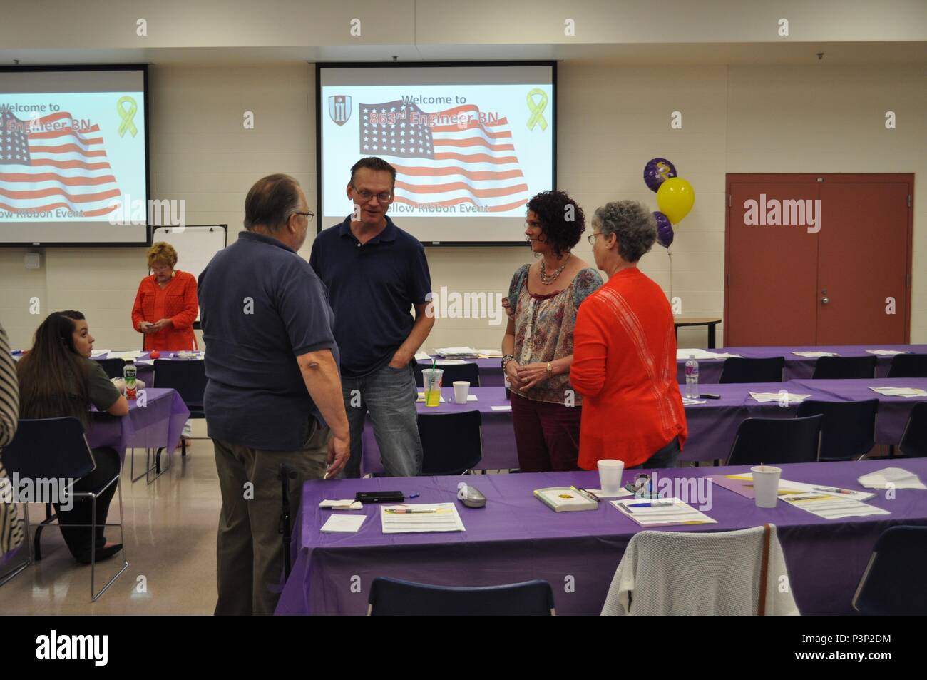 Family members and guests discuss the presentations provided at the ...