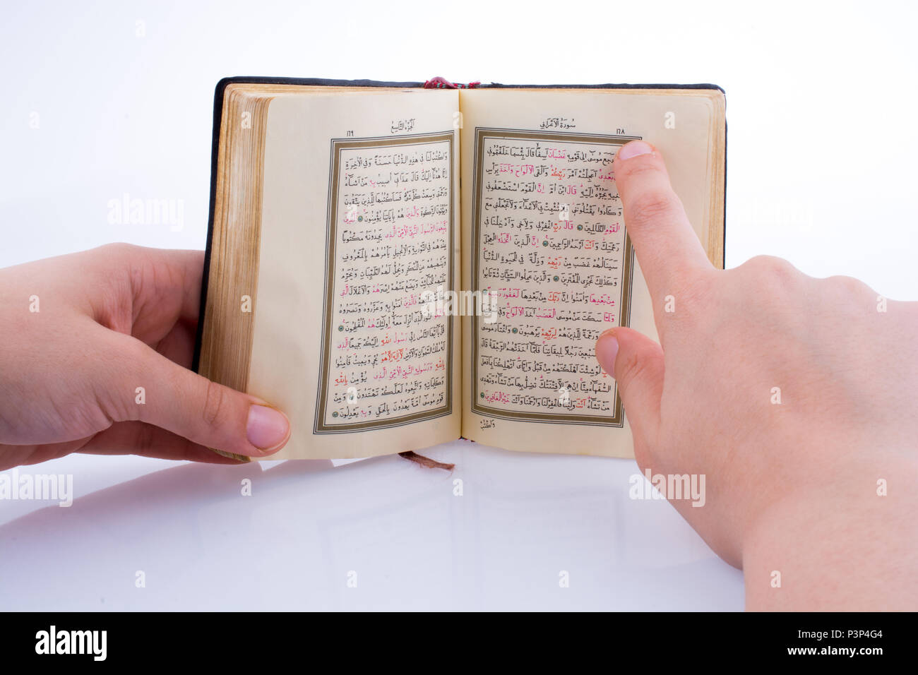 Hand holding The Holy Quran on a white background Stock Photo - Alamy