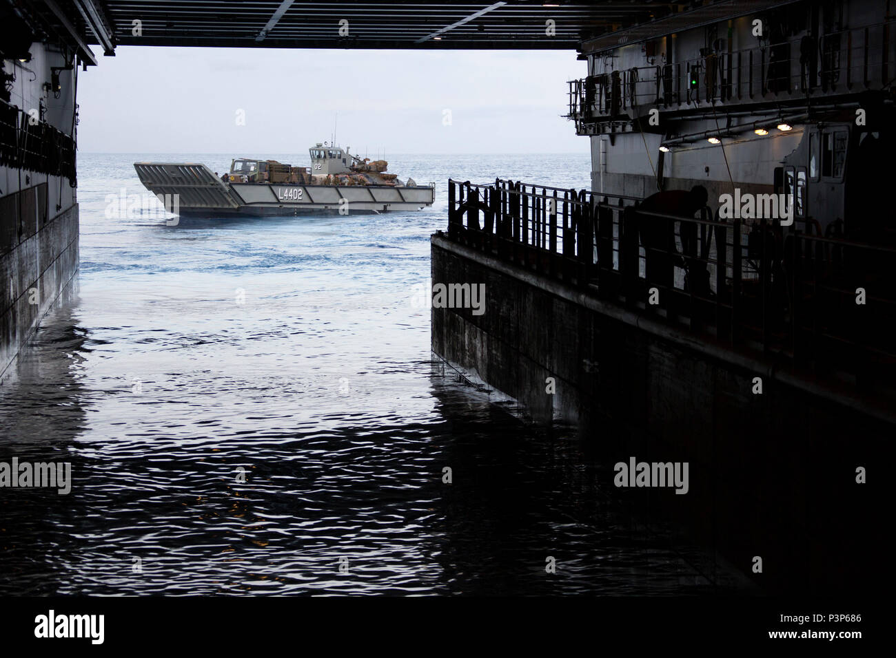 A Royal Australian Navy LHD Landing Craft departs the well dock of HMAS ...