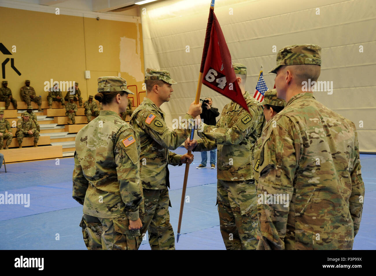 U.S. Army Lt. Col. Paul C. Graves passes the guidon to Lt. Col. Brett J. Taylor, incoming ...