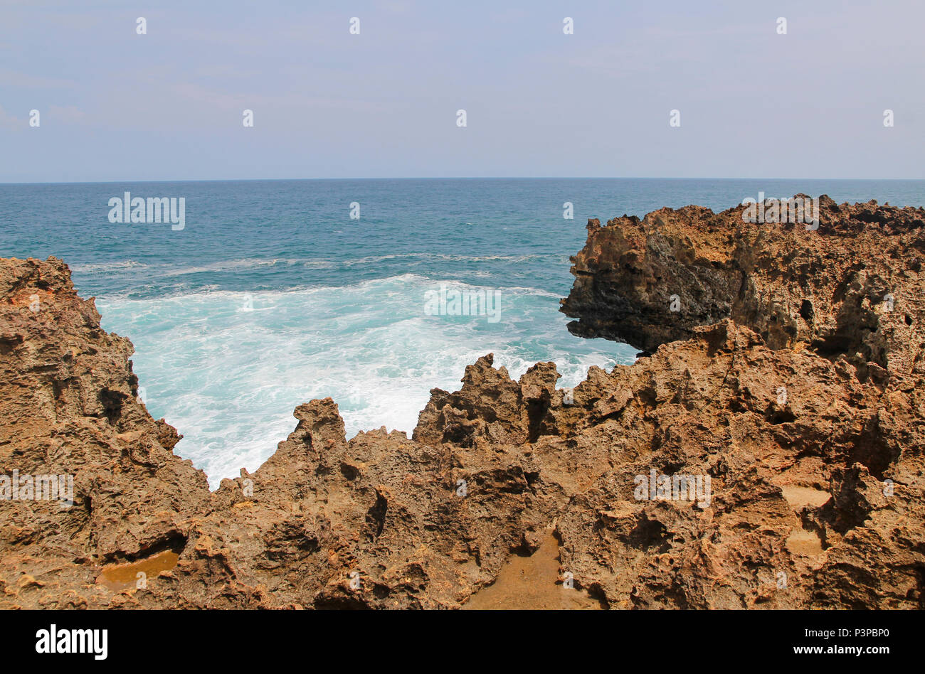 Natural rock formation with the wave at Timang Beach in sunny day ...