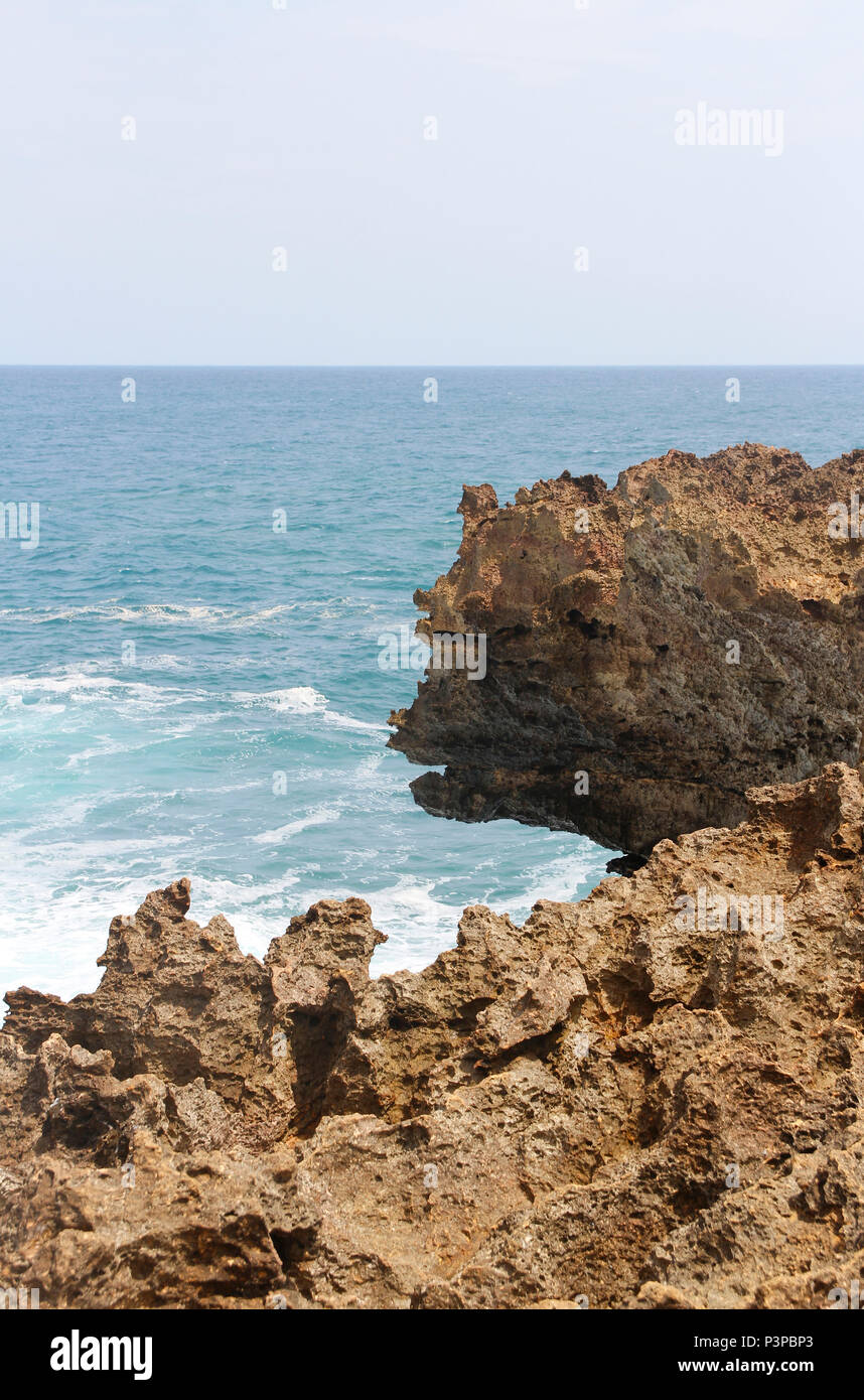 Natural rock formation with the wave at Timang Beach in sunny day ...