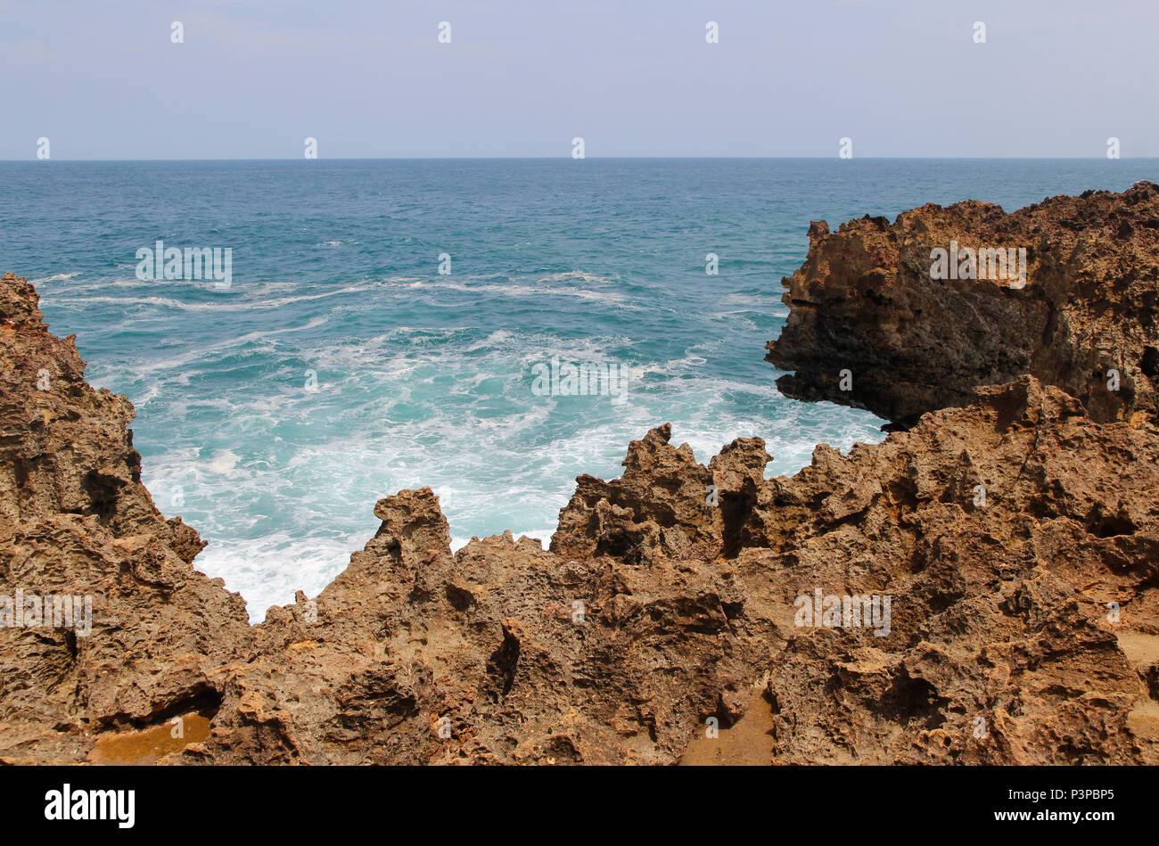 Natural rock formation with the wave at Timang Beach in sunny day ...
