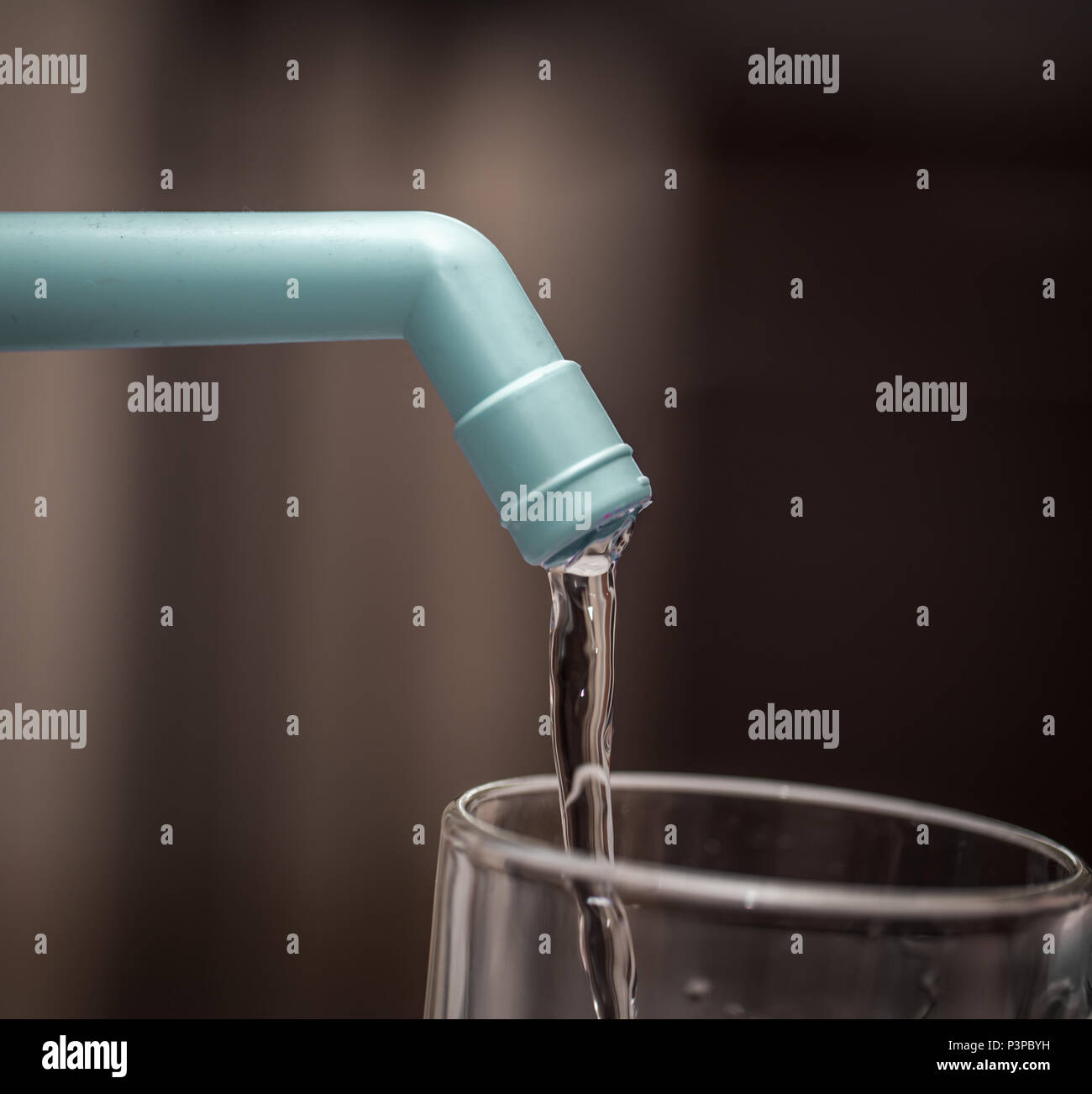 Water filter is poured into a transparent glass closeup Stock Photo - Alamy
