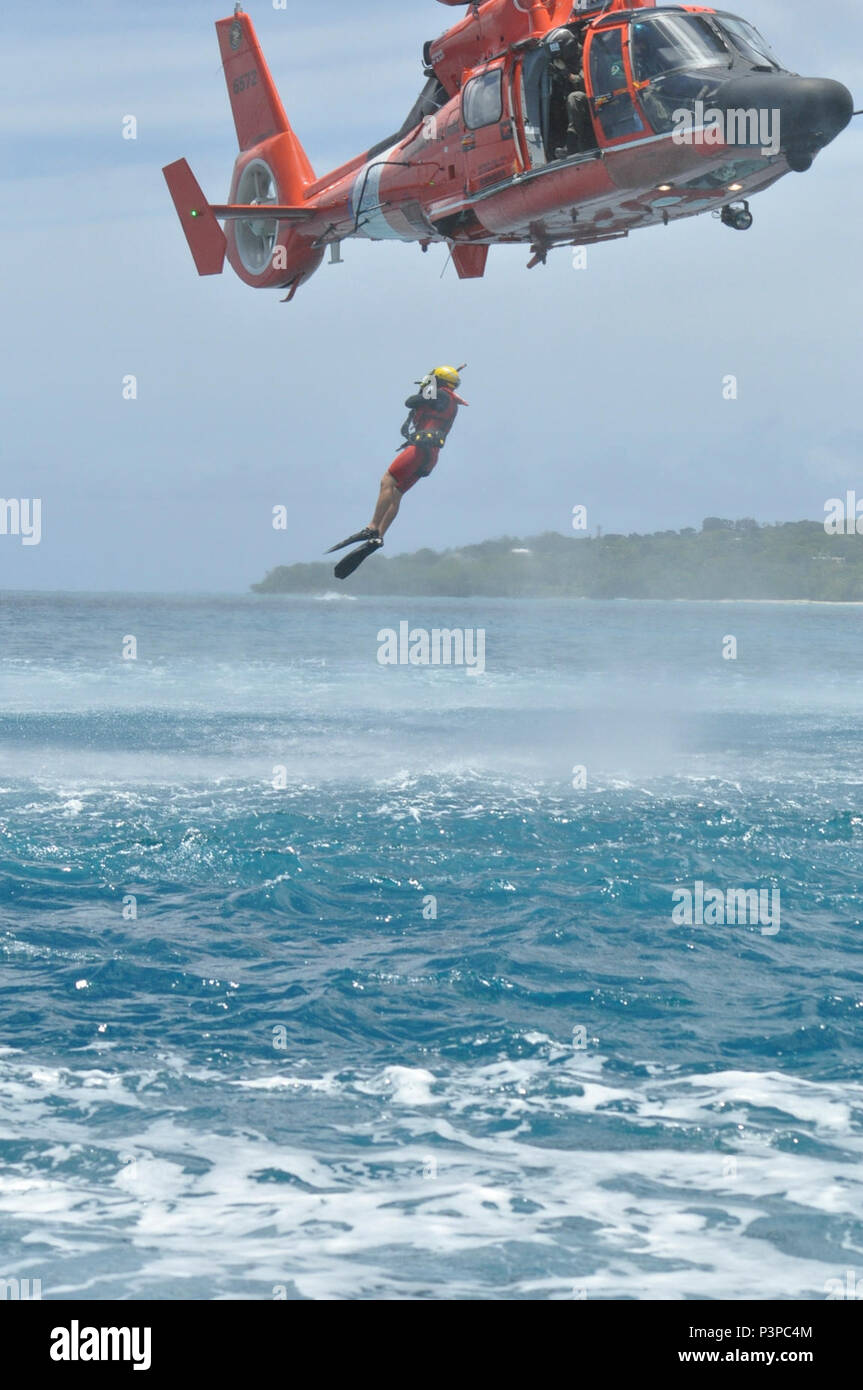 U.S. Coast Guard rescue diver jumps into the water to "rescue" members ...