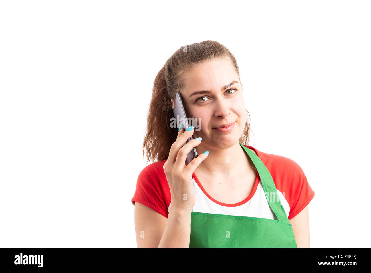 Young female storekeeper or retail worker using smartphone and making a ...