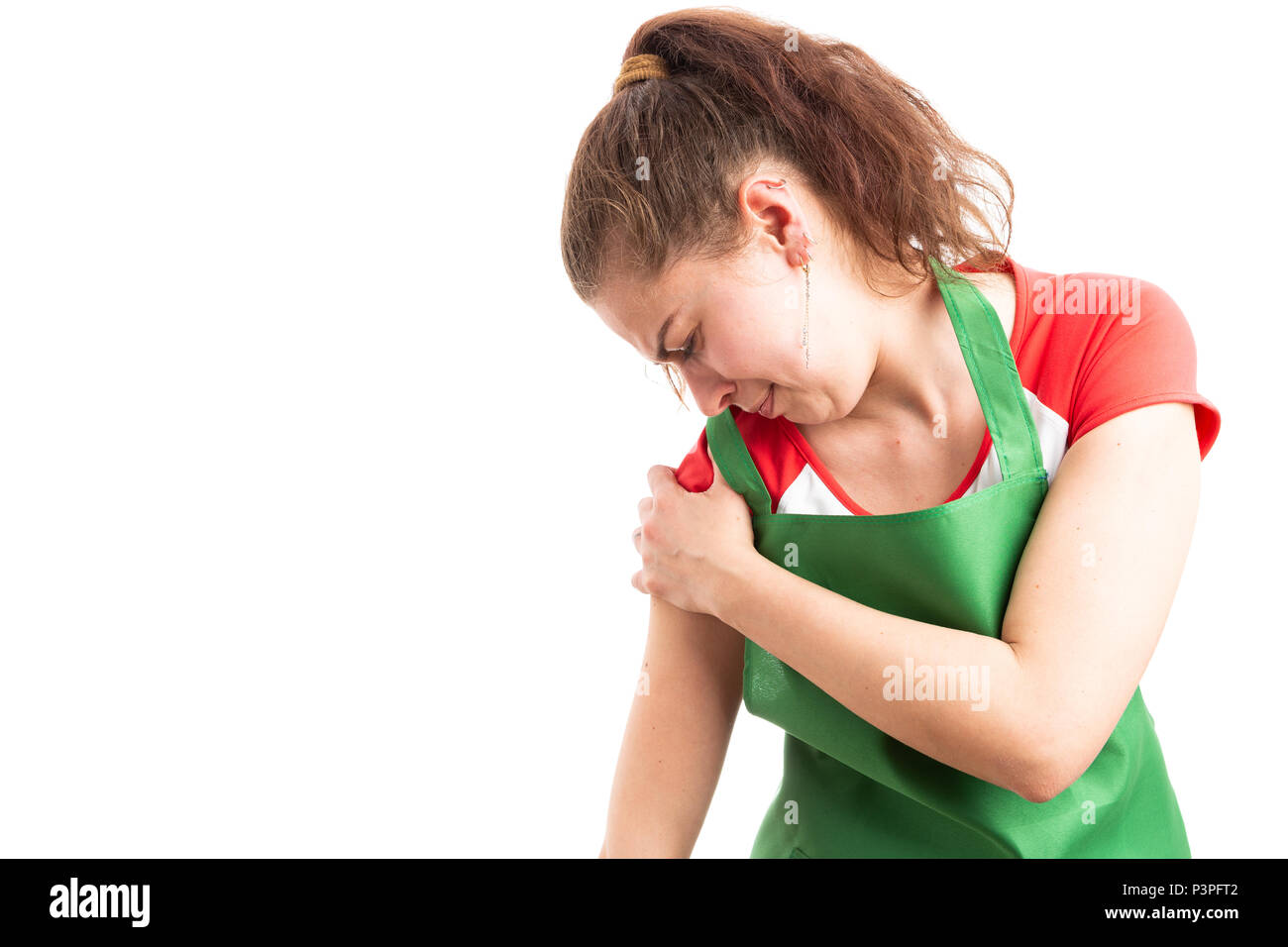 Young female supermarket or hypermarket employee suffering shoulder ...