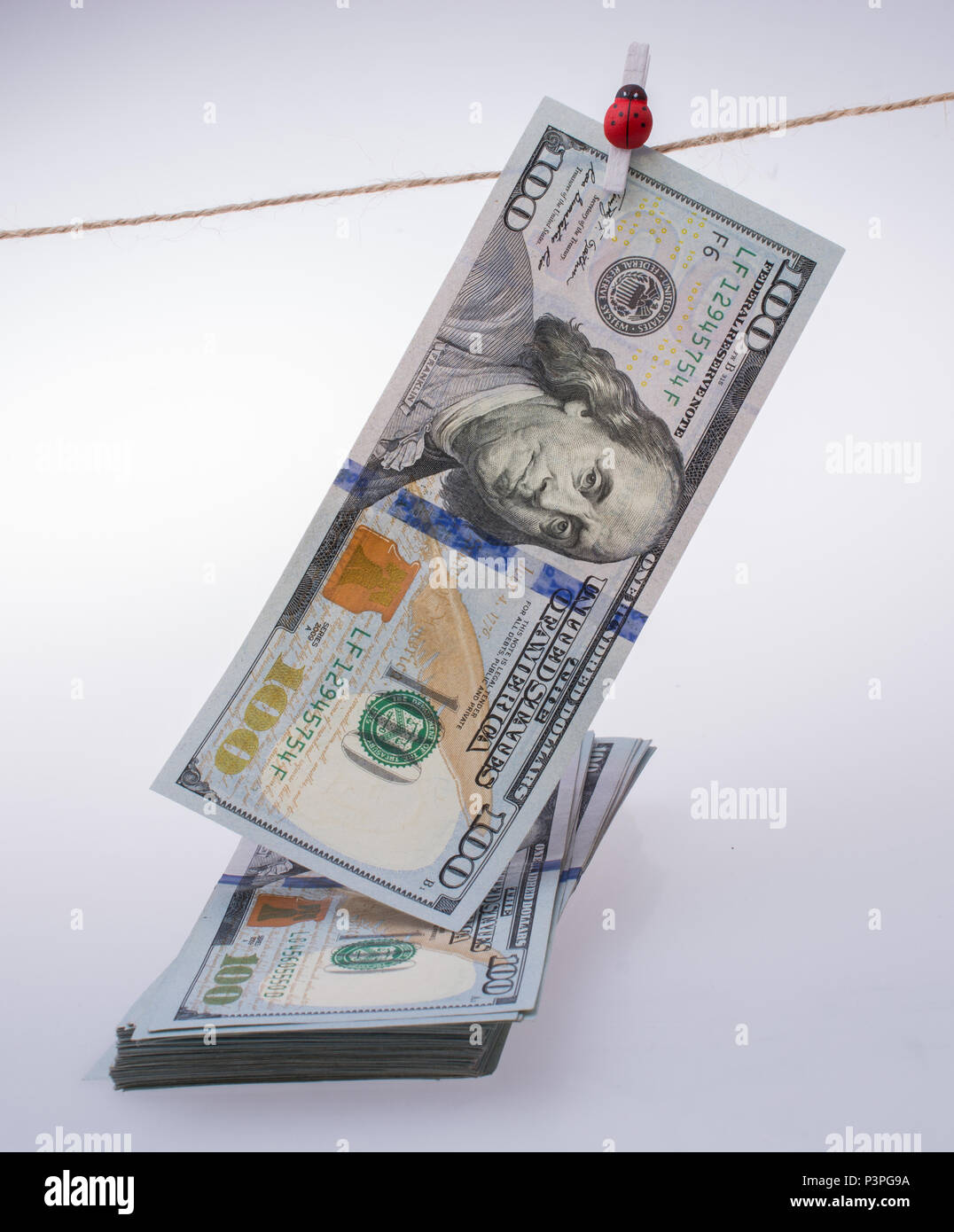 Banknote of US dollar hanging on a linen string Stock Photo - Alamy