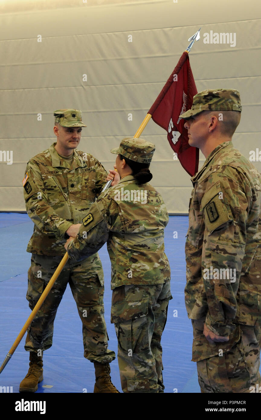 U.S. Army Lt. Col. Brett J. Taylor, incoming commander, passes the guidon to Sgt. 1st Class ...