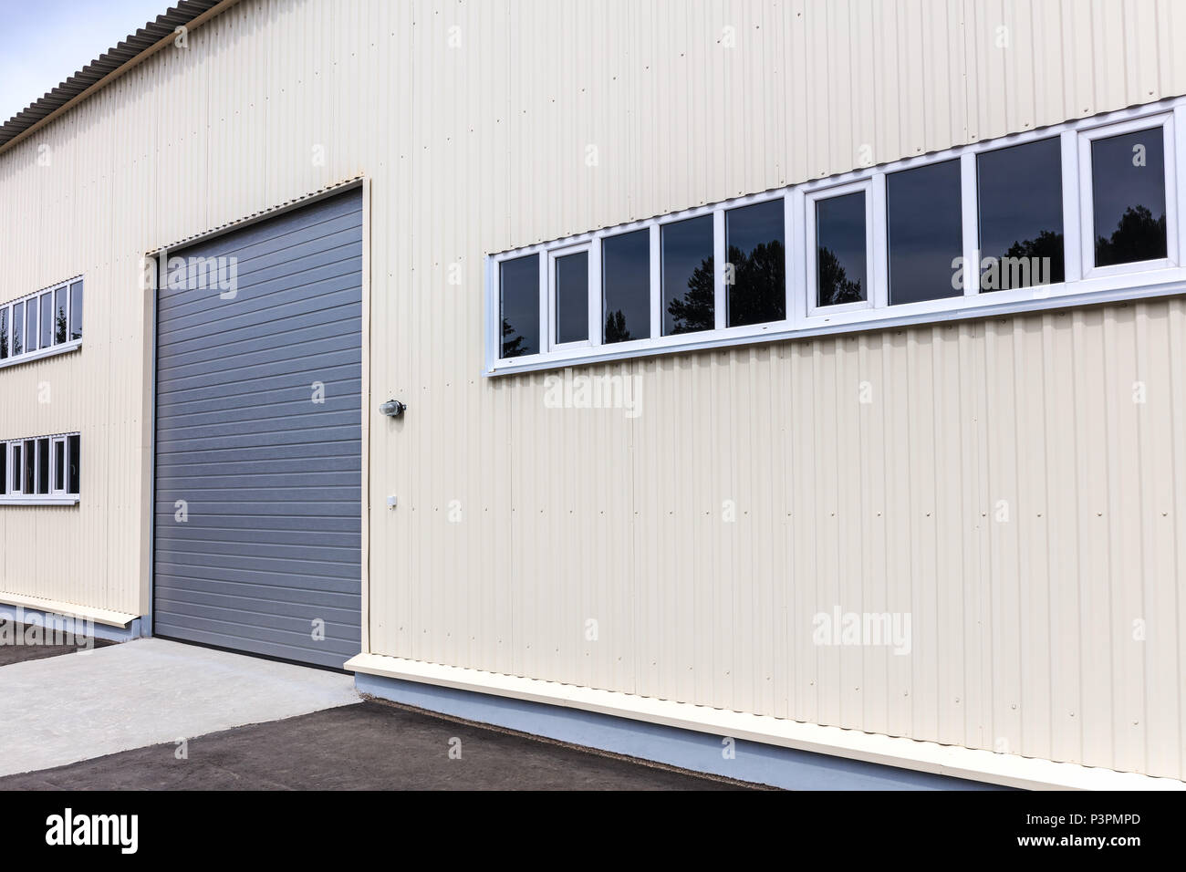 new storehouse building wall with closed roller shutter gate Stock ...