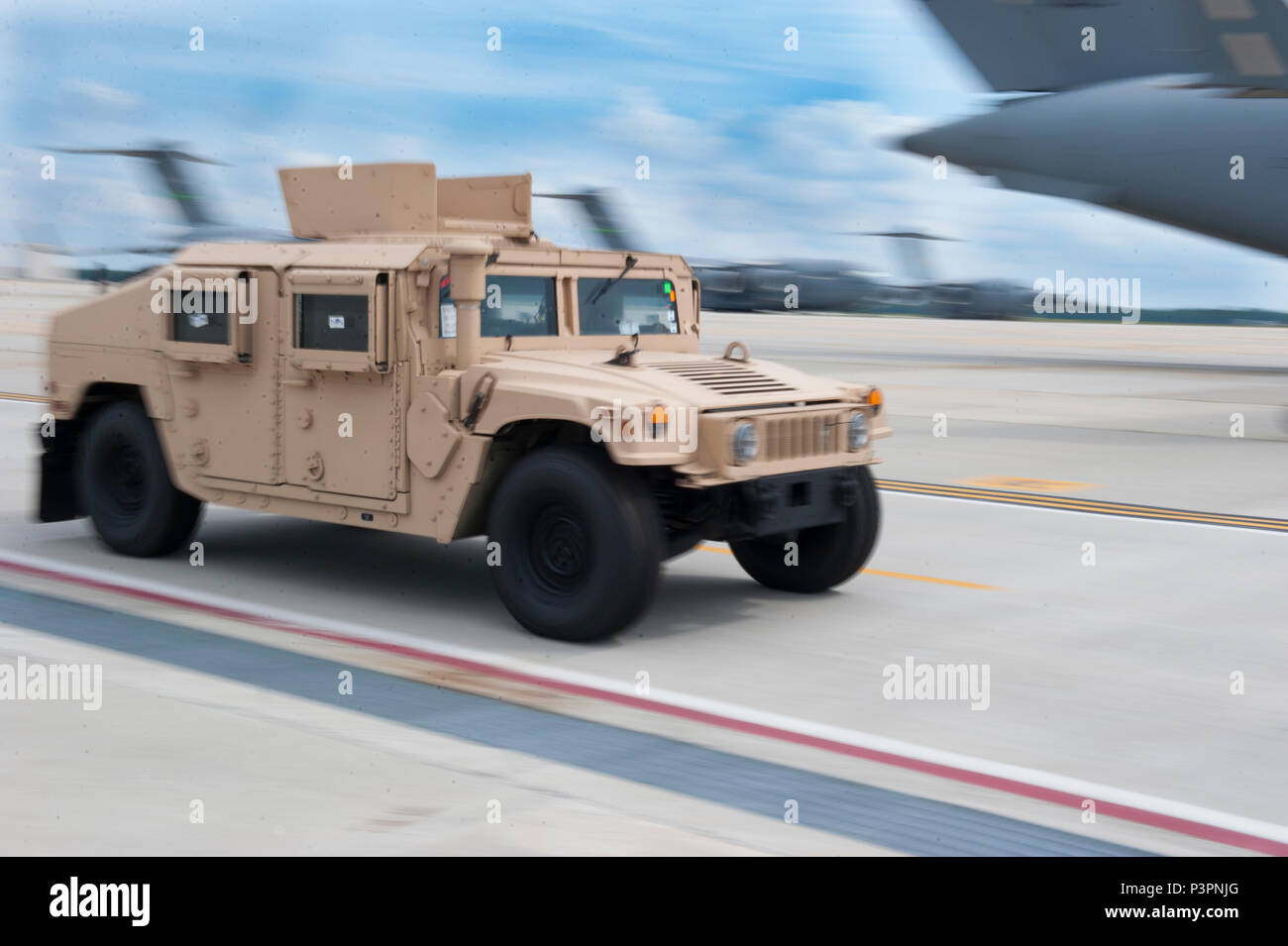 A member of the 305th Aerial Port Squadron drives a Humvee along the ...
