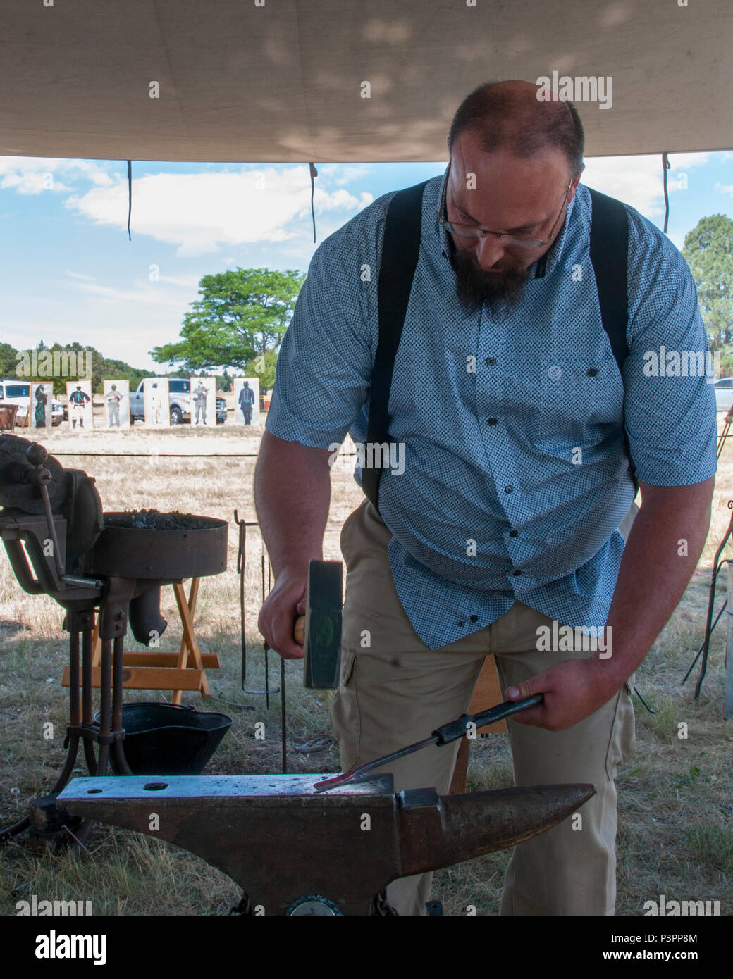 Retired Staff Sgt. Andrew Nofzinger hammers a new decorative hook July ...