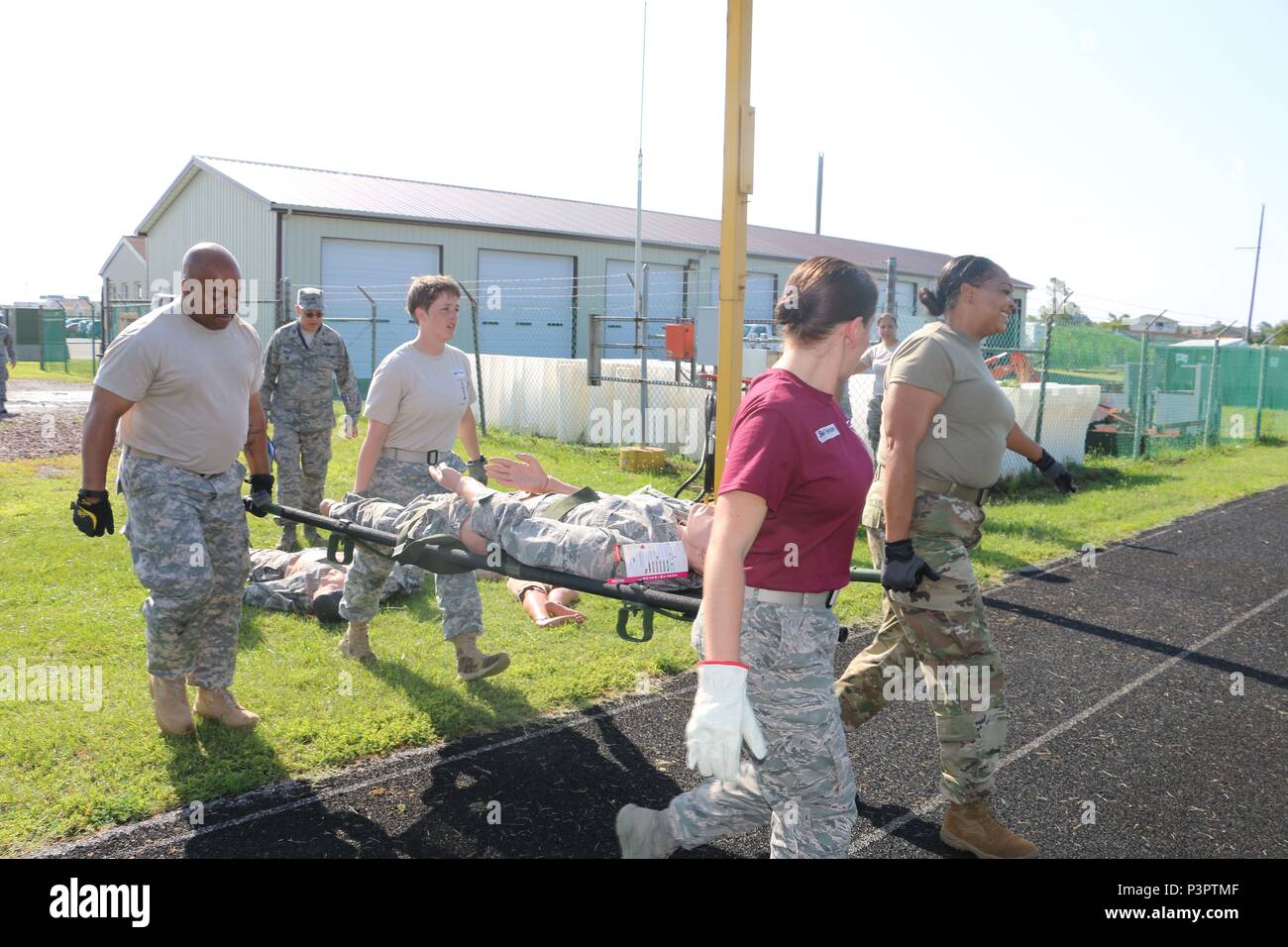 Soldiers and Airmen from the Delaware National Guard use the four man ...