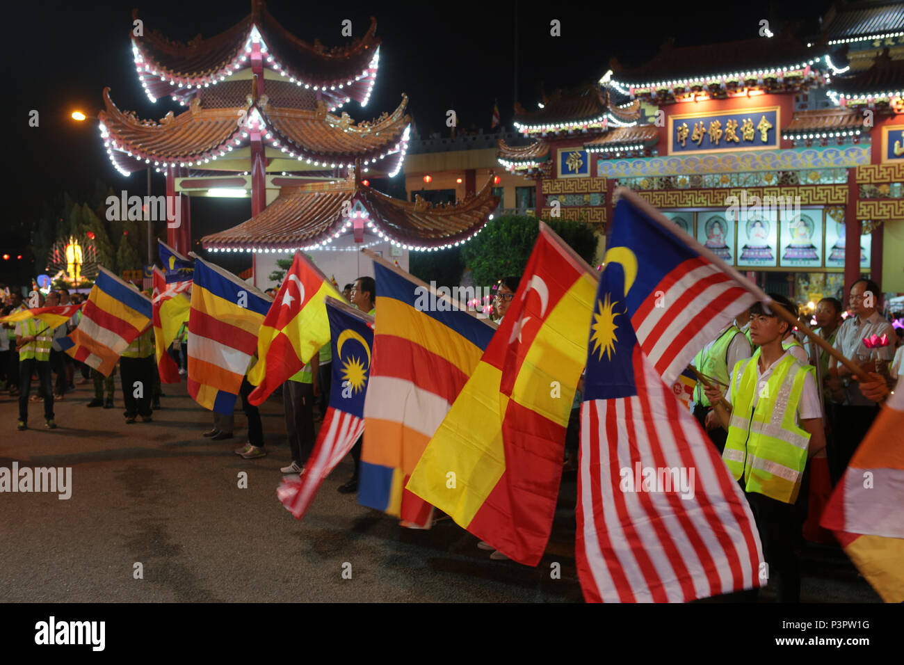 People flying buddhist and national flags at the wesak day parade at ...