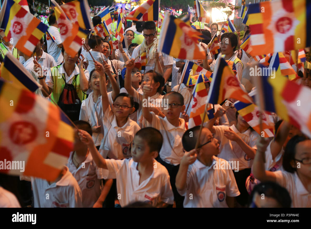 Children flying the buddhist flags in wesak day parade at PPMS buddhish ...