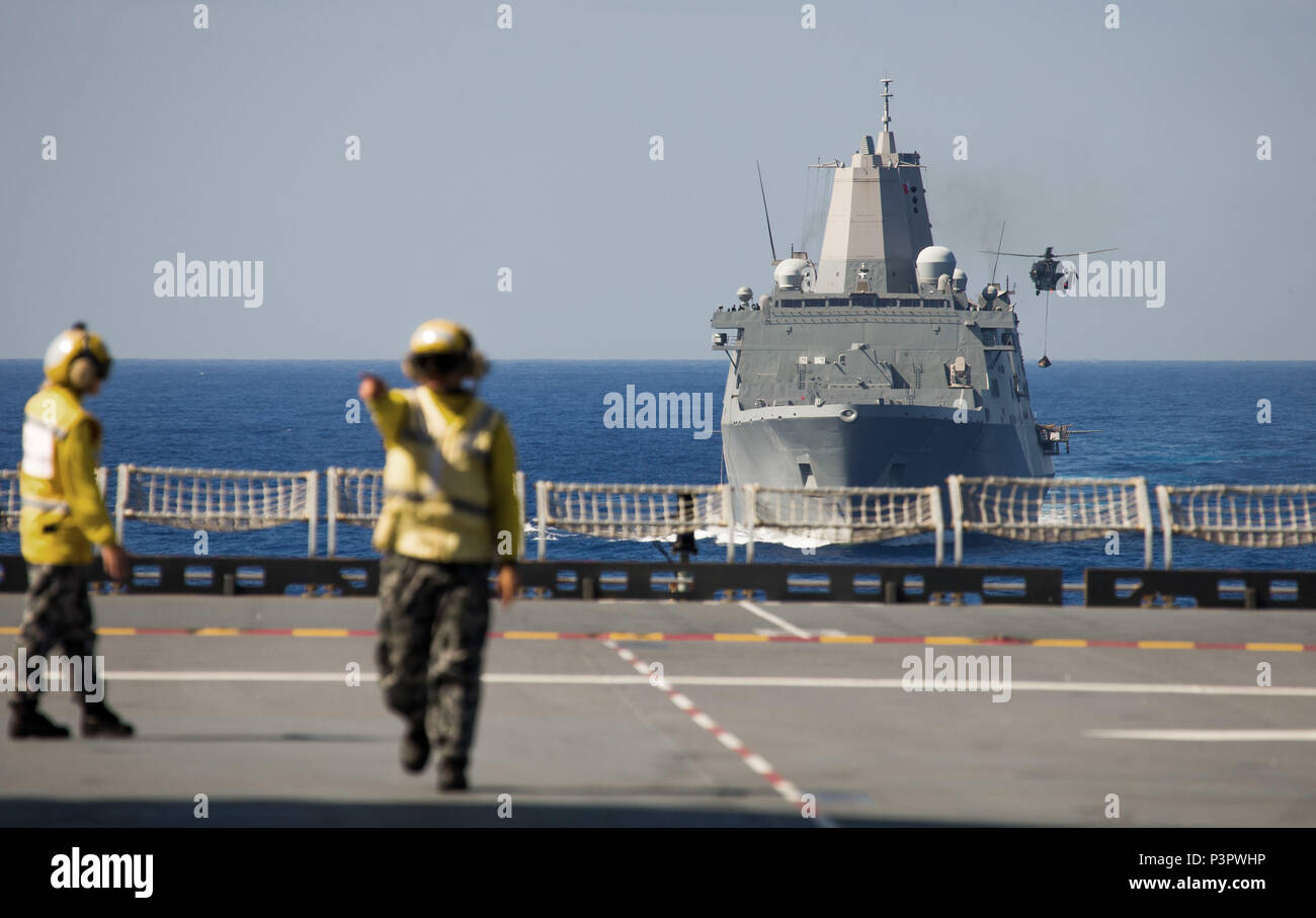 HMAS Canberra's embarked MRH-90 helicopter conducts a vertical ...