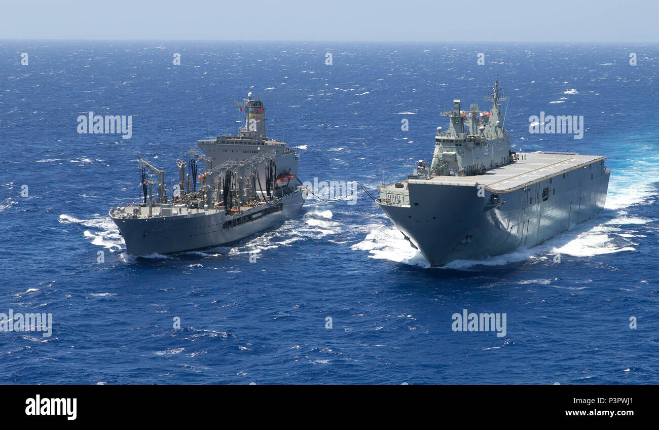 HMAS Canberra (right) conducts a replenishment at sea (RAS) with ...